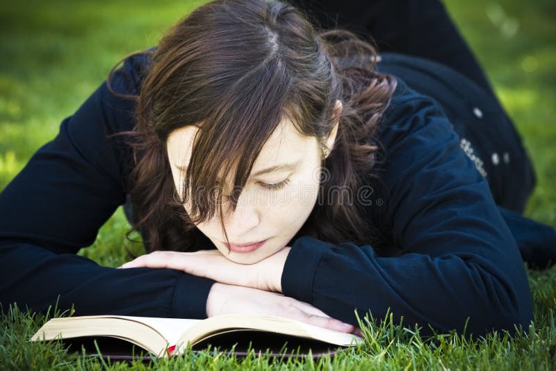 Reading on the grass stock image. Image of enjoyment, model - 4404035