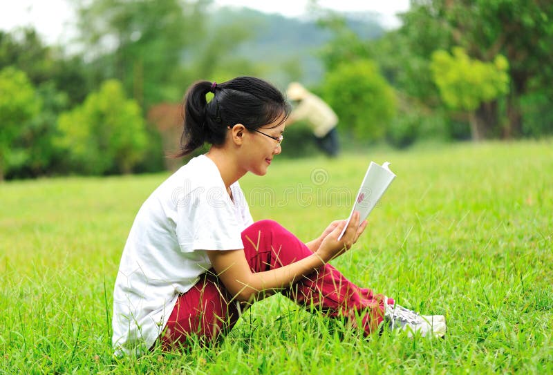 Reading on green grass stock image. Image of casual, land - 26746801