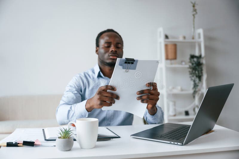 Reading Information from Document. Businessman is Working in the Office ...