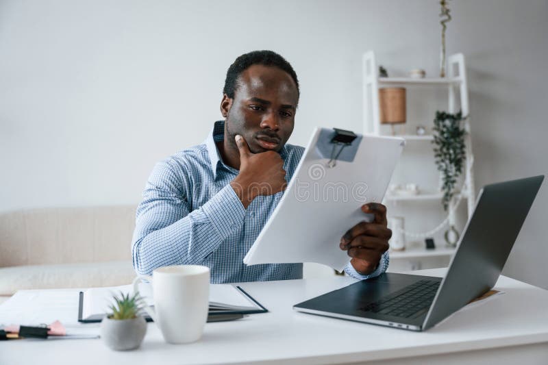 Reading Information from Document. Businessman is Working in the Office ...