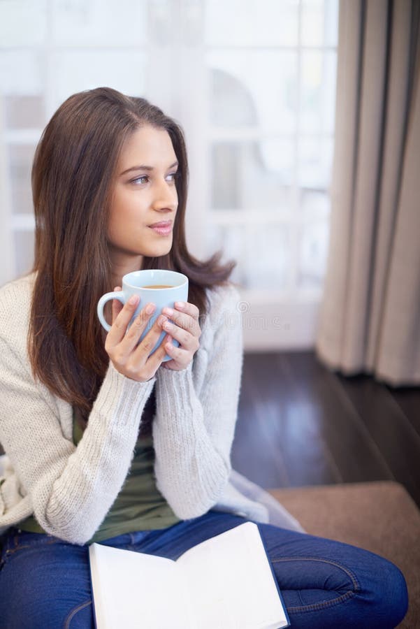 Reading an Interesting Article. a Young Woman Reading a Book at Home ...