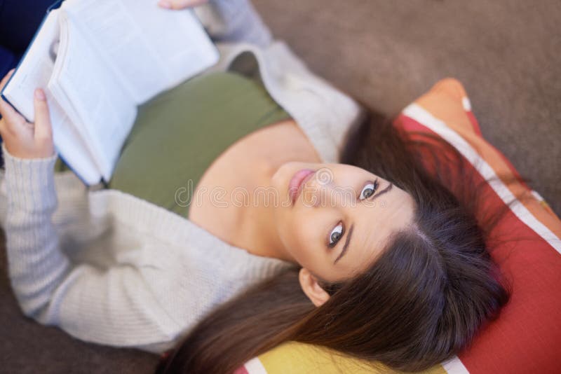 Reading an Interesting Article. a Young Woman Reading a Book at Home ...