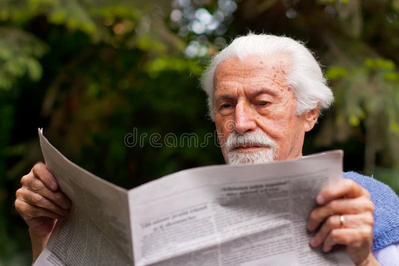 Reading the newspaper stock photo. Image of holding, outdoor - 20129584