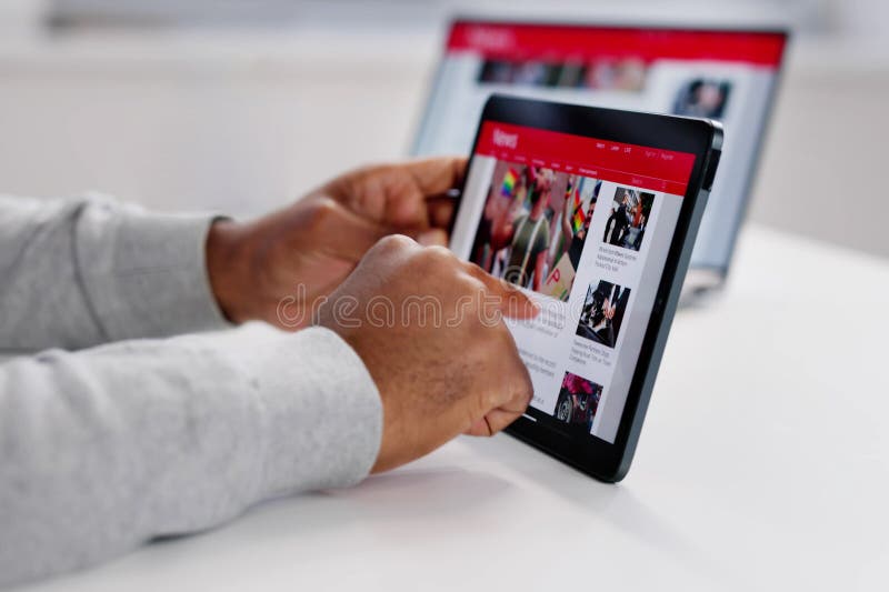 Reading Newspaper Article on Tablet Stock Photo - Image of electric ...