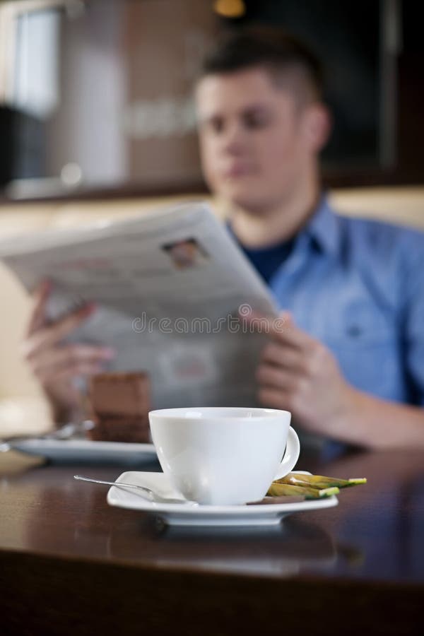 Reading newspaper in cafe stock image. Image of table - 29173477