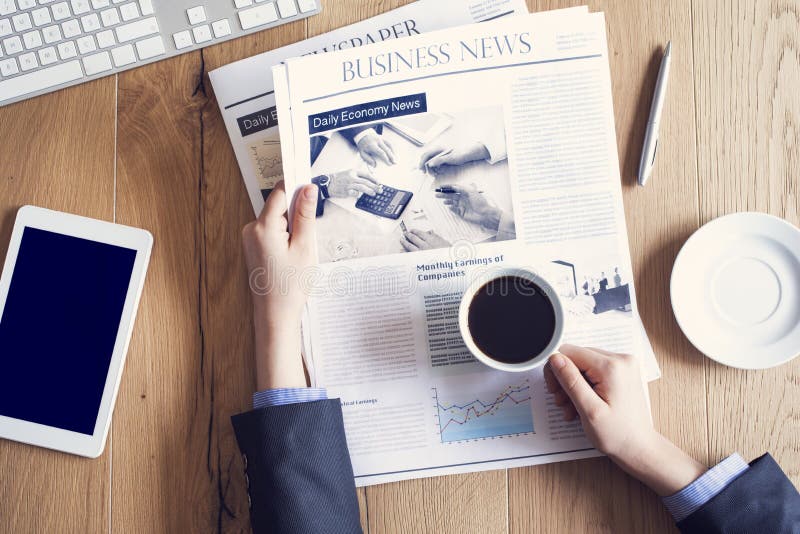 Reading newspaper on desk stock image. Image of finance - 93992179