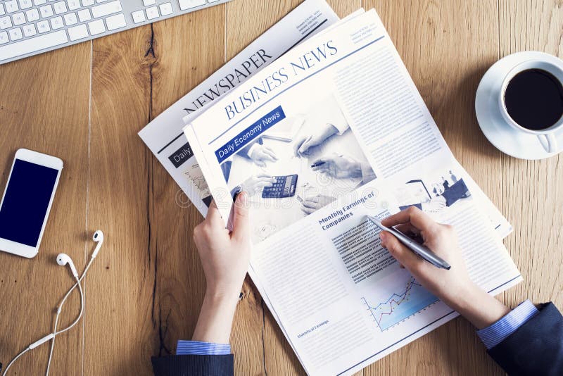 Reading newspaper on desk stock photo. Image of person - 93992392
