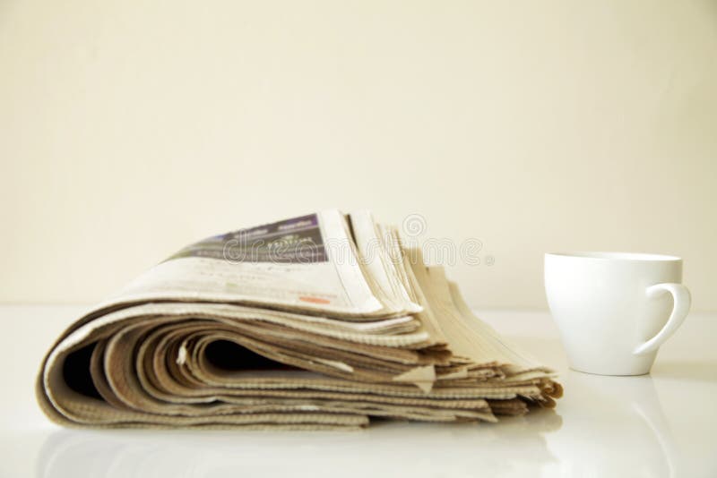 Reading newspaper on table stock image. Image of news - 102757123