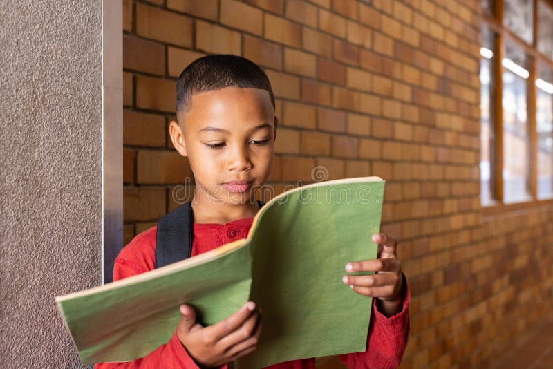 Reading Notebook, Boy Standing in School Hallway with Backpack on Stock ...