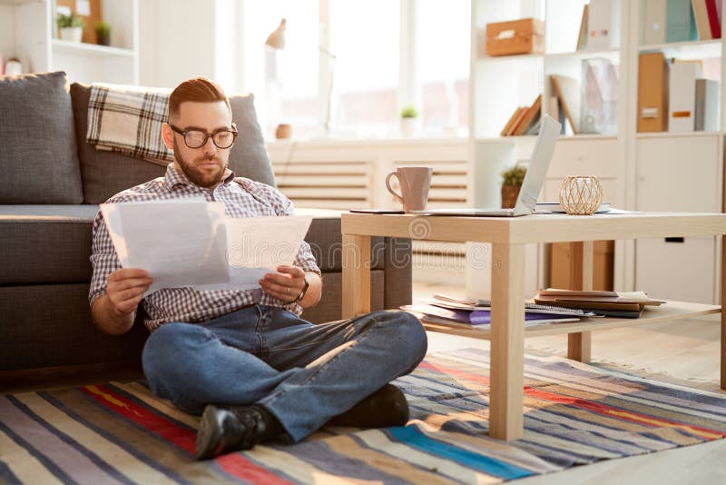Reading papers at home stock image. Image of table, confident - 143436709