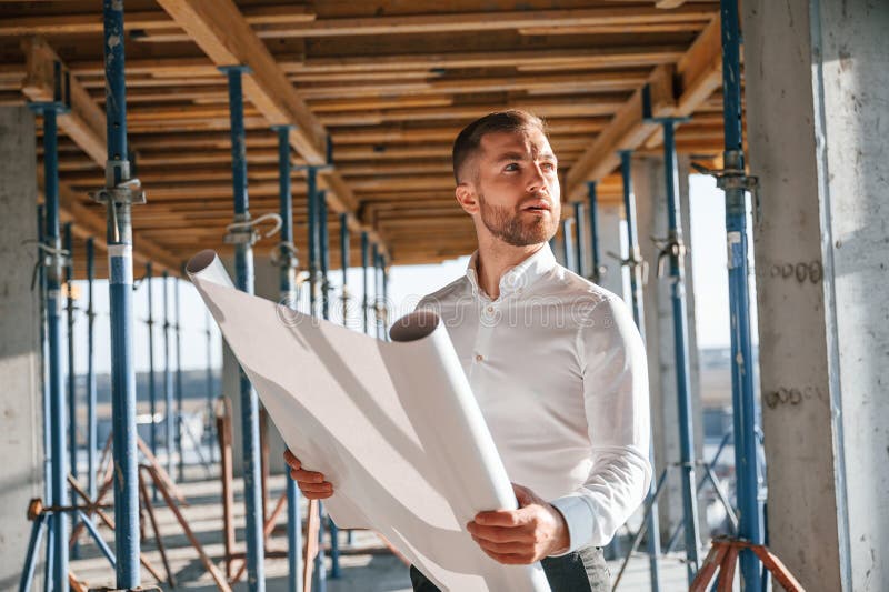 Reading the Plan. Man is Working on the Construction Site at Daytime ...