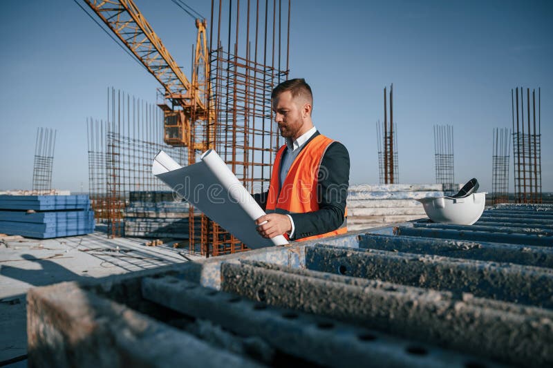 Reading the Plan. Man is Working on the Construction Site at Daytime ...