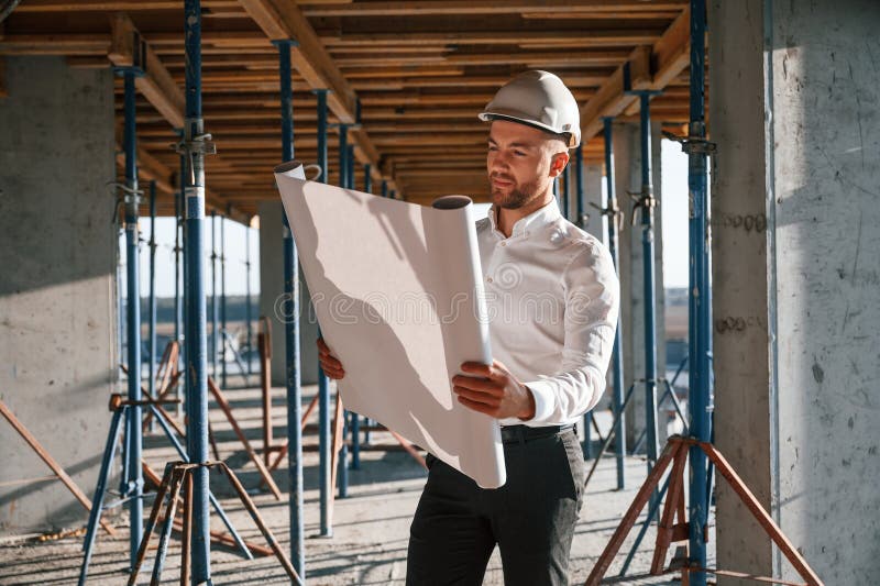 Reading the Plan. Man is Working on the Construction Site at Daytime ...