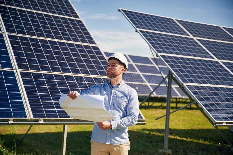Reading the Plan on Paper. Engineer with Photovoltaic Solar Panels ...