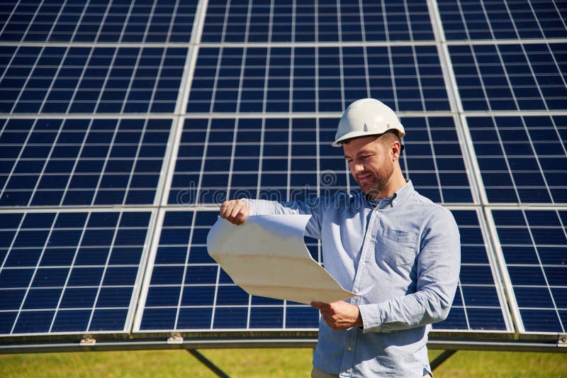 Reading the Plan on Paper. Engineer with Photovoltaic Solar Panels ...