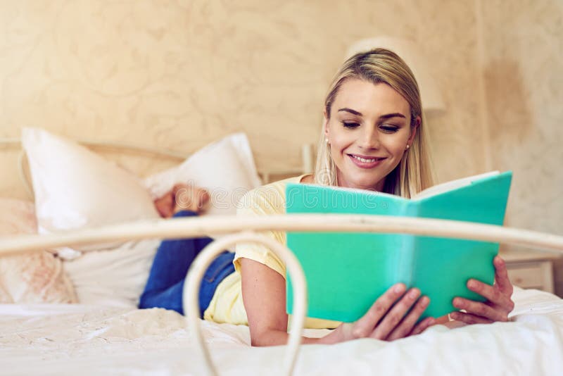 Reading For Relaxation A Young Woman Reading A Book While Lying On Her