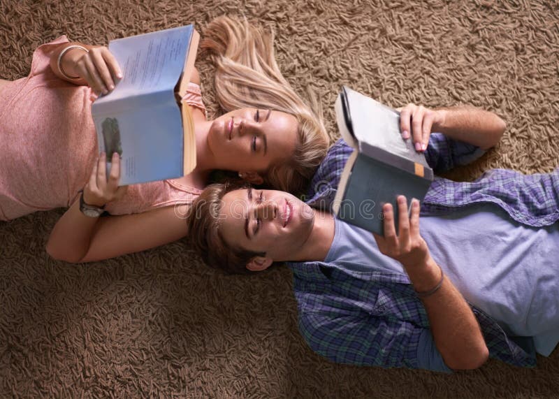 Reading while Relaxed. Two College Students Lying on the Floor while ...
