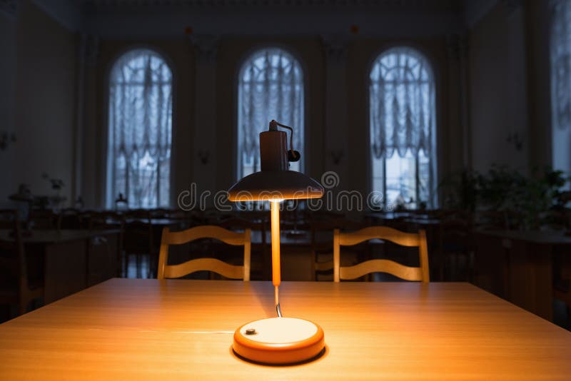 Reading at the Table with a Lamp in the Library Stock Photo - Image of ...