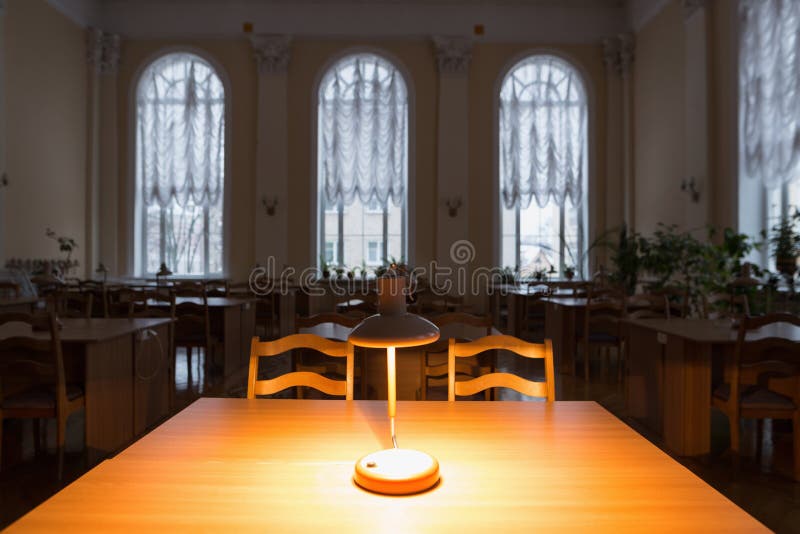 Reading at the Table with a Lamp in the Library Stock Photo - Image of ...
