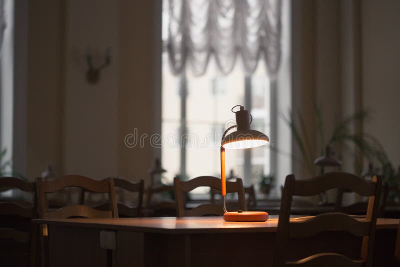 Reading at the Table with a Lamp in the Library Stock Photo - Image of ...