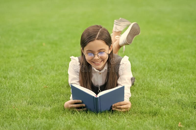Reading Time. Happy Schoolgirl Reading Book Lying on Grass after School ...
