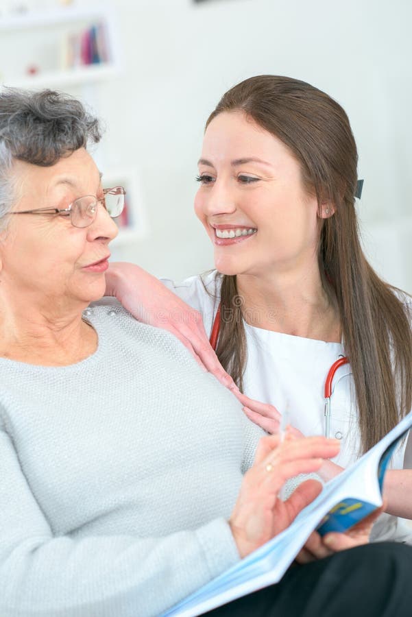 Man Reading To Patient In Hospital Bed Stock Image - Image of aloud ...