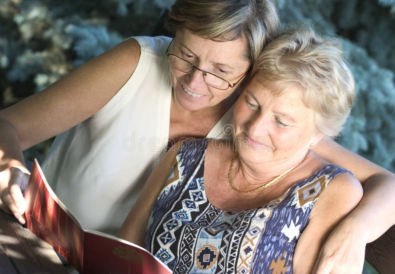 Reading together stock image. Image of friendship, middleaged - 912755