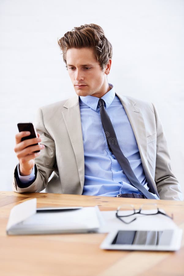 Reading an Urgent Text. a Young Businessman Reading a Text Message from ...