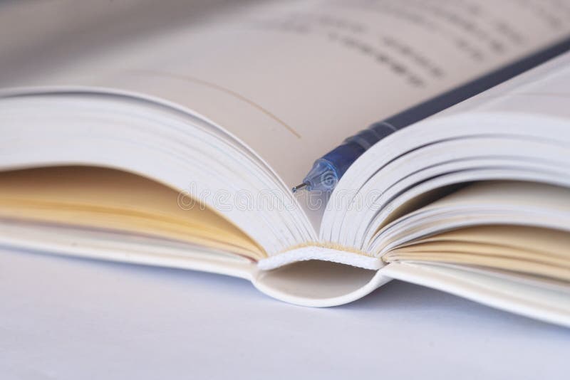 Reading and Writing,Put a Ball Point Pen on the Unfolded Page. Stock ...