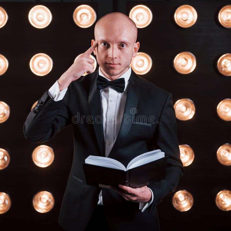 Reading Your Mind. Magician in Black Suit Standing in the Room with ...