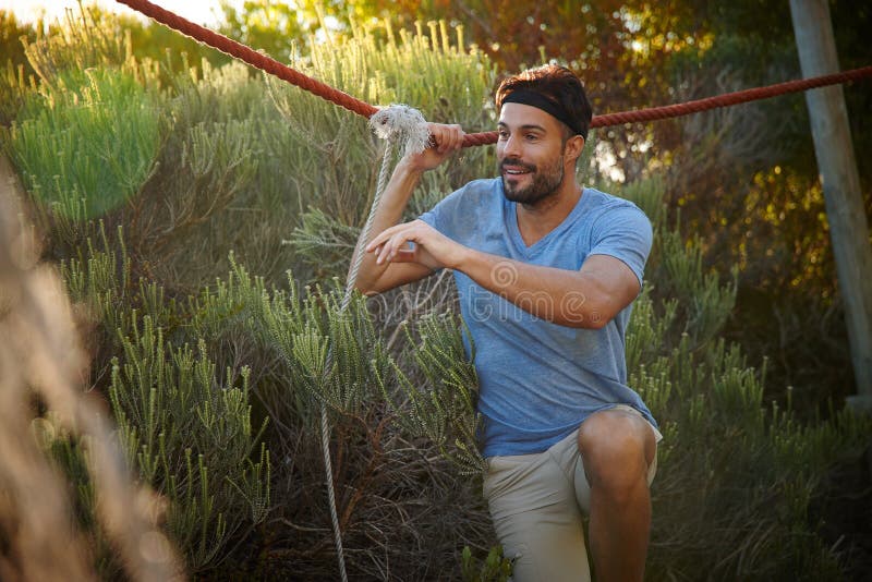 Ready for Action. a Man Going through an Obstacle Course at Bootcamp ...