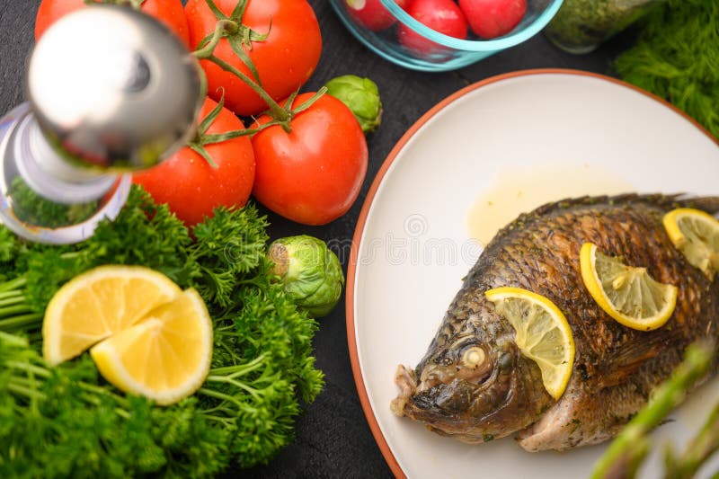 Ready Cooked Fish on a Background with Vegetables. Cooking Recipes ...