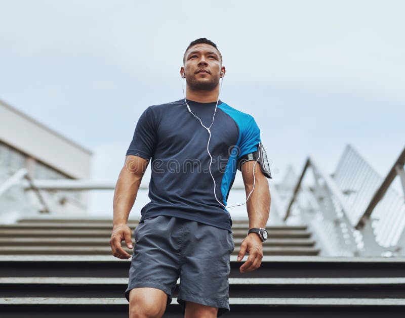 So Ready for this. Low Angle Shot of a Male Runner Standing on Steps in ...