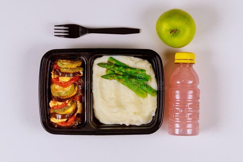 Ready Meal To Eat on Food Container with Drink and Apple Stock Image ...