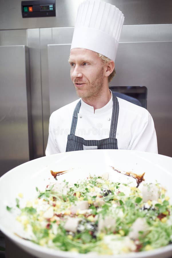 Ready for Service. a Chef Holding a Large Bowl of Salad in a ...