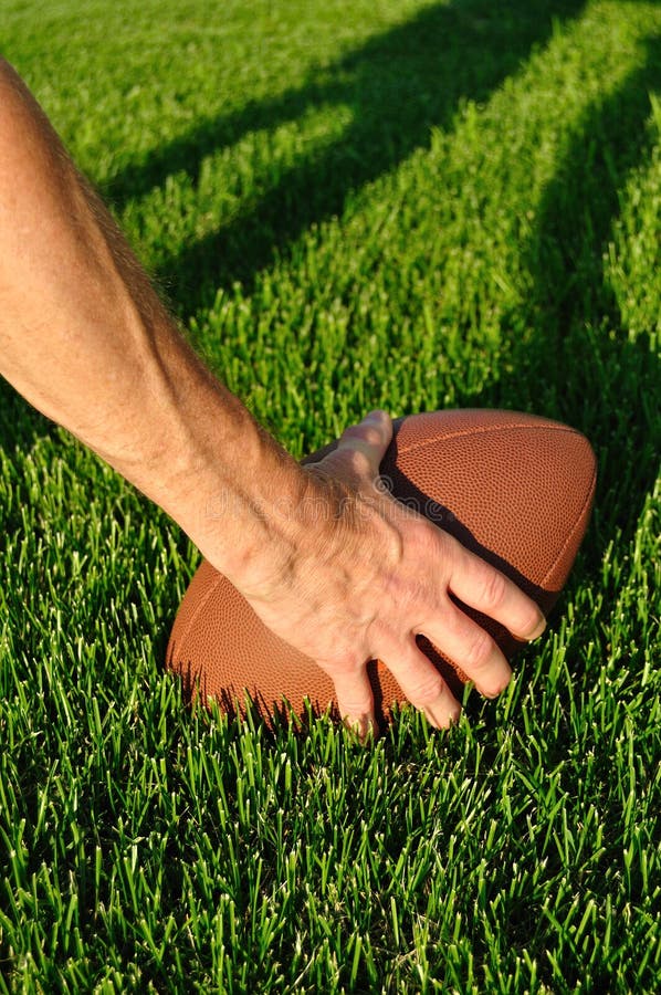 Ready To Hike Football on a Grass Playing Field Stock Image - Image of ...