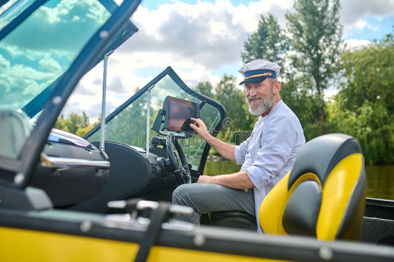 A Man in a Captains Cap Getting the Boat Ready Stock Photo - Image of ...