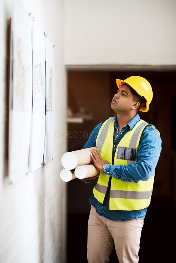 Ready To Turn Ideas into Action. a Young Engineer Reading Something on ...