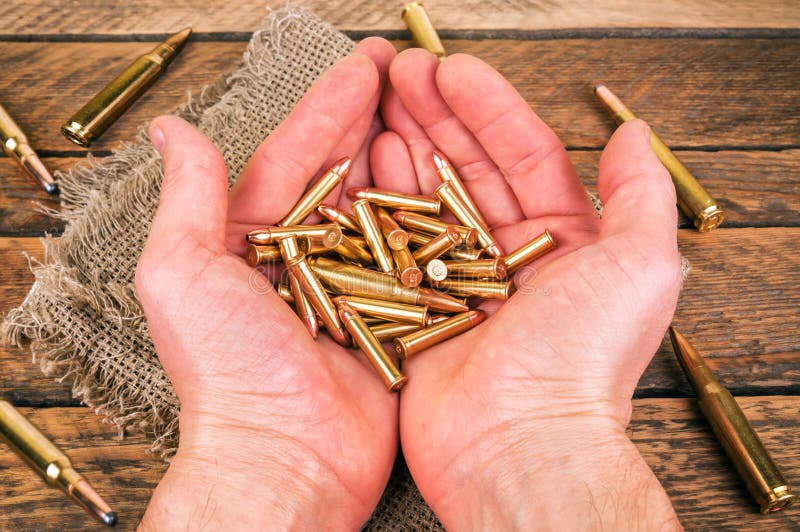 Real bullets in the hands stock image. Image of bullets - 116264467