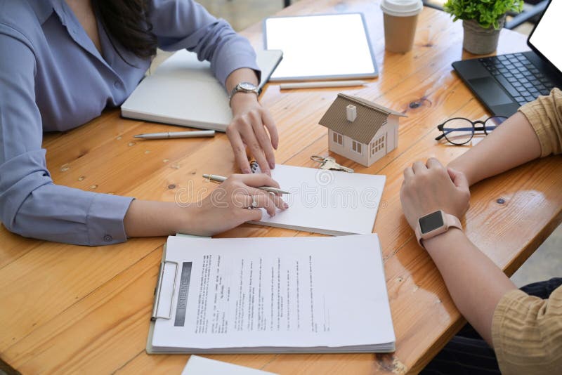 Real Estate Agent Explaining Contract Details for Customer. Stock Image ...