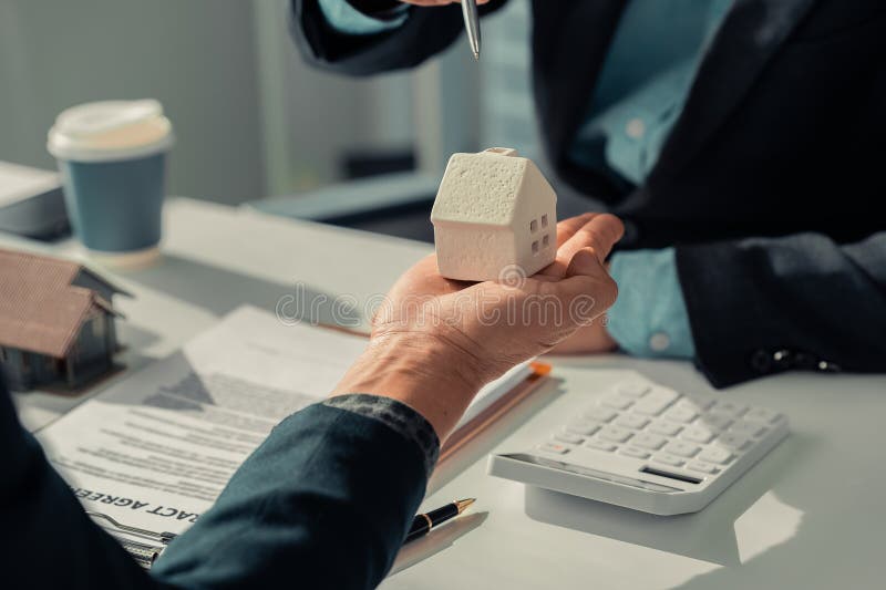 A Real Estate Agent is Explaining the Terms of a Home Purchase Contract ...