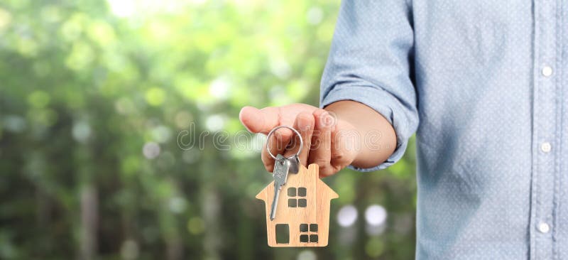 Real Estate Agent Handing Over House Keys in Hand Stock Photo - Image ...