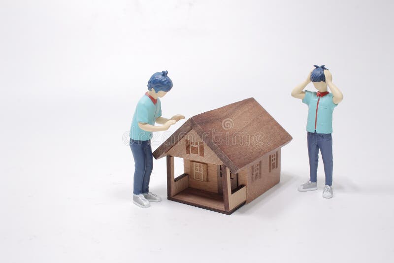 Real Estate Agent Holding a House Stressed with Hand on Head Stock ...