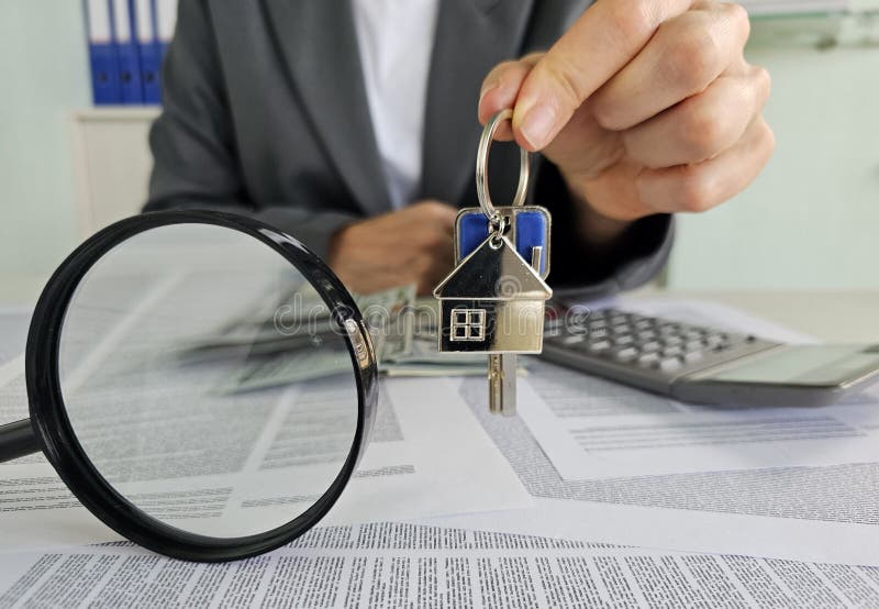 Real Estate Agent Presenting House Keys with Calculator and Documents ...
