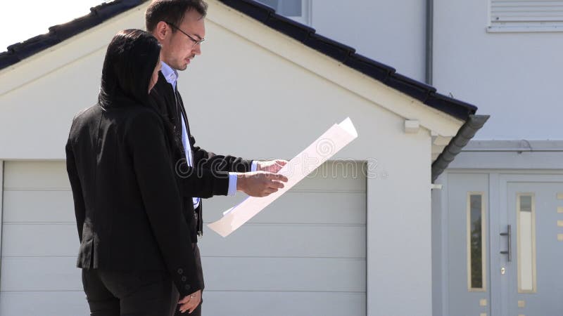 A Real Estate Agent Showing a Customer House Plan Stock Footage - Video ...