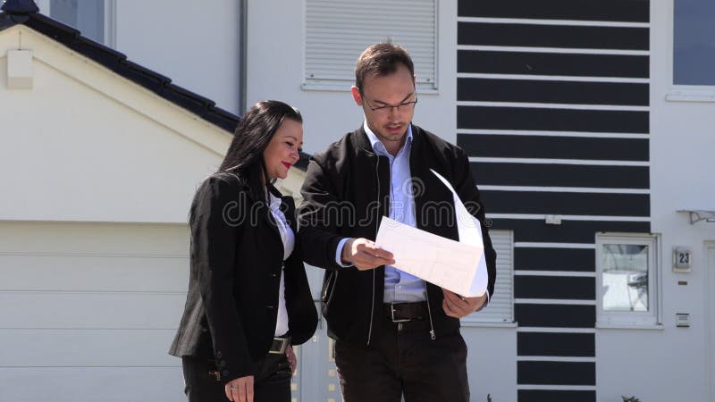 A Real Estate Agent Showing a Customer House Plan Stock Footage - Video ...