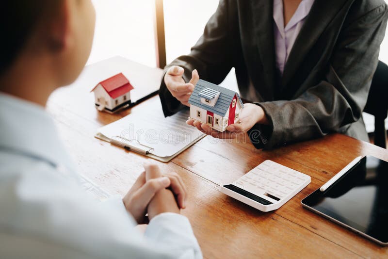 The Real Estate Agent is Showing the House Model To the Customer Stock ...