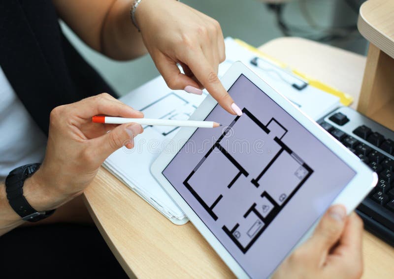 Real-estate Agent Showing House Plans on Electronic Tablet. Stock Photo ...