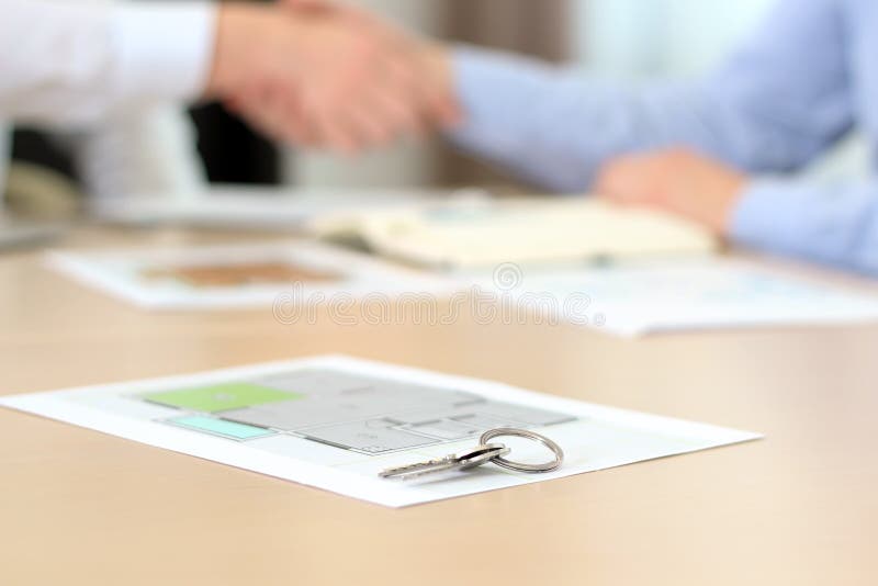 Real-estate Agent Signing a Contract. Handshake. a House Key with ...