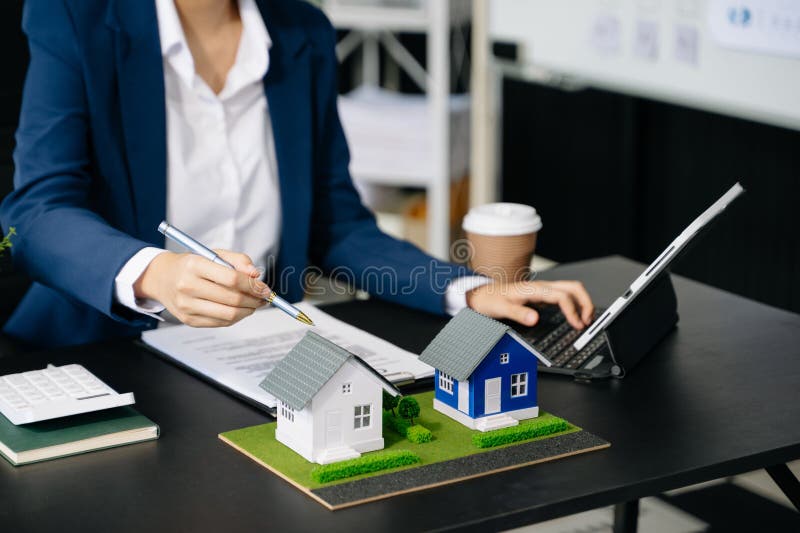 Real Estate Agent Worker Working with Laptop and Tablet at Table in ...